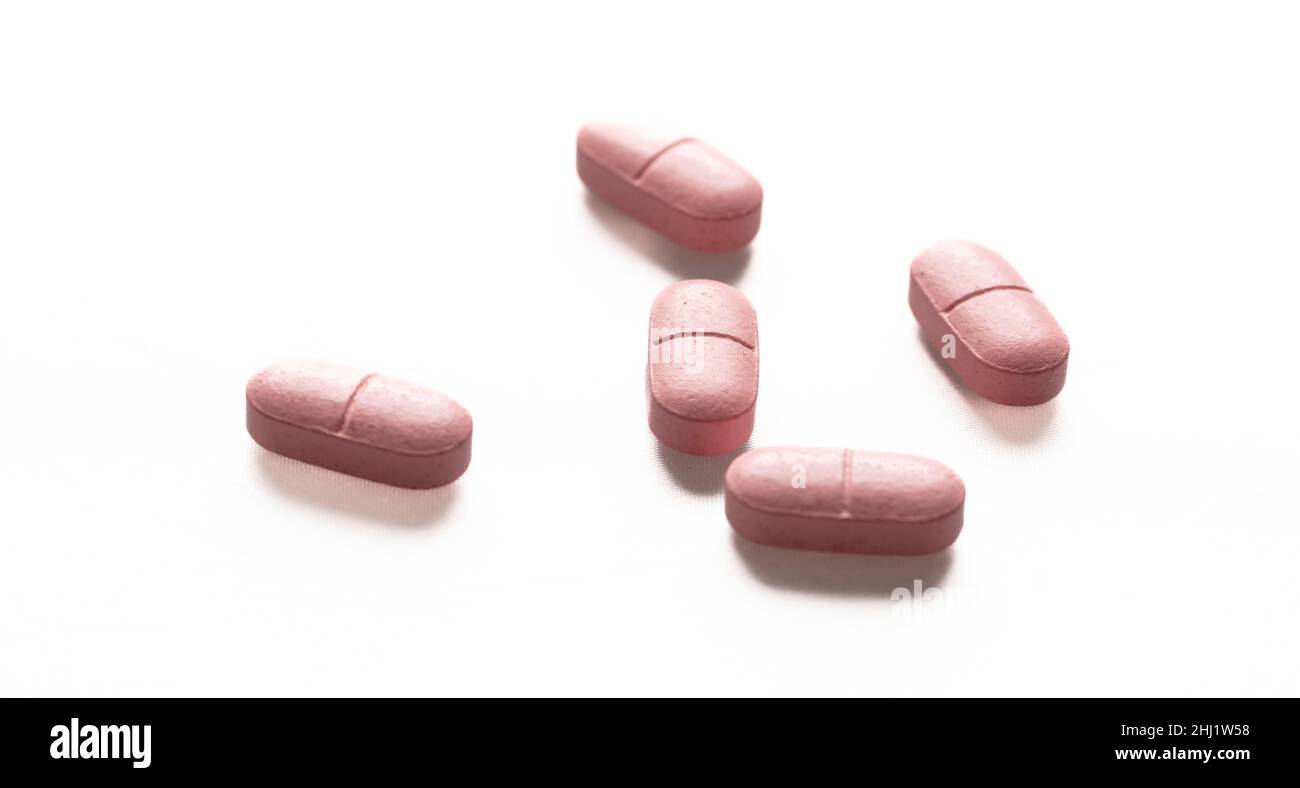 Medicine pill isolated cutout on white color background. Pink tablets ...