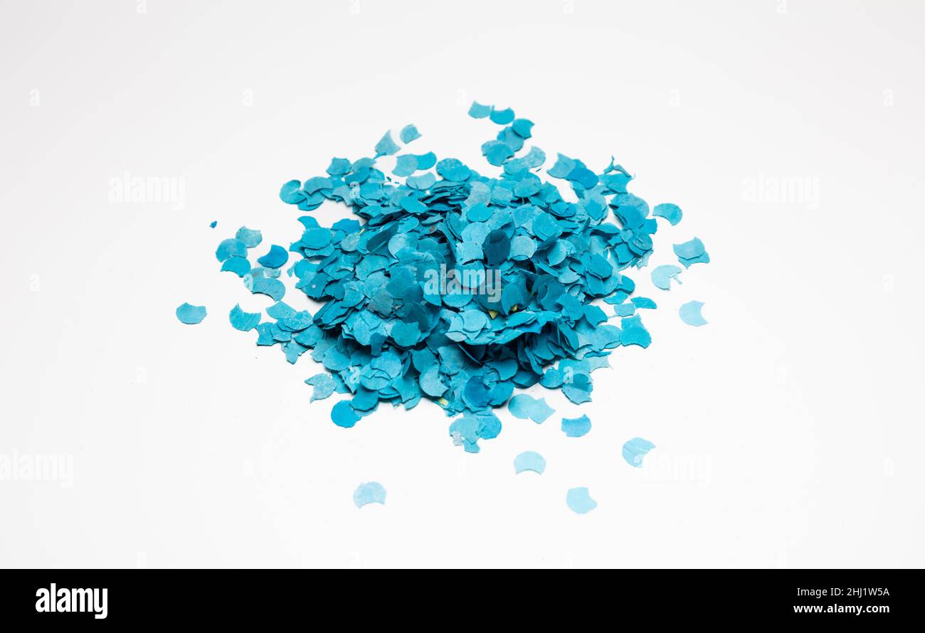 Confetti blue color heap isolated cutout on white background. Overhead ...