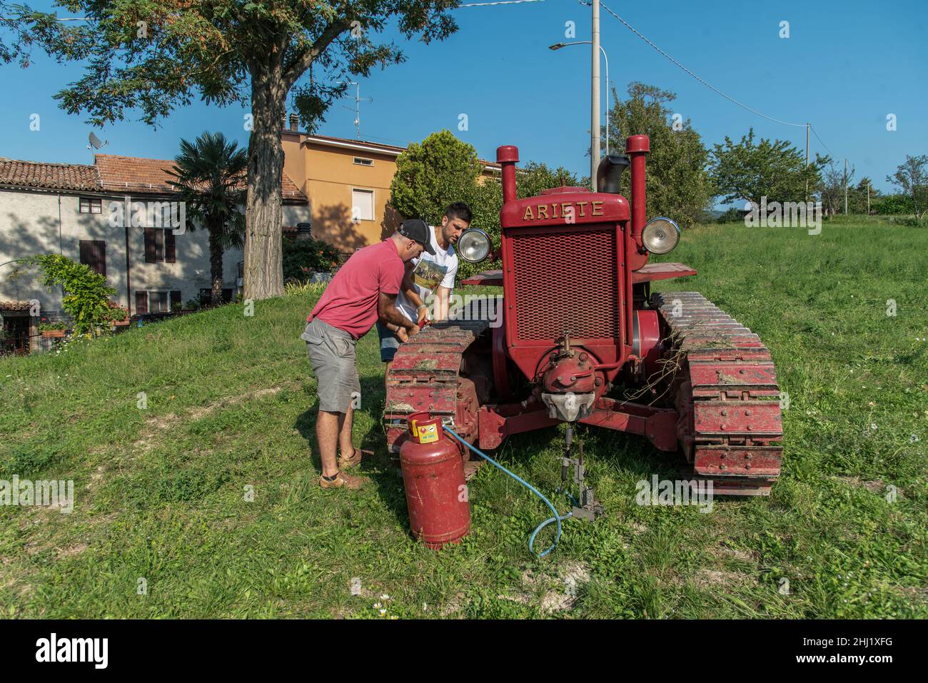 Italian boys start the engine of a Bubba Ariete, hot-headed tractor ...