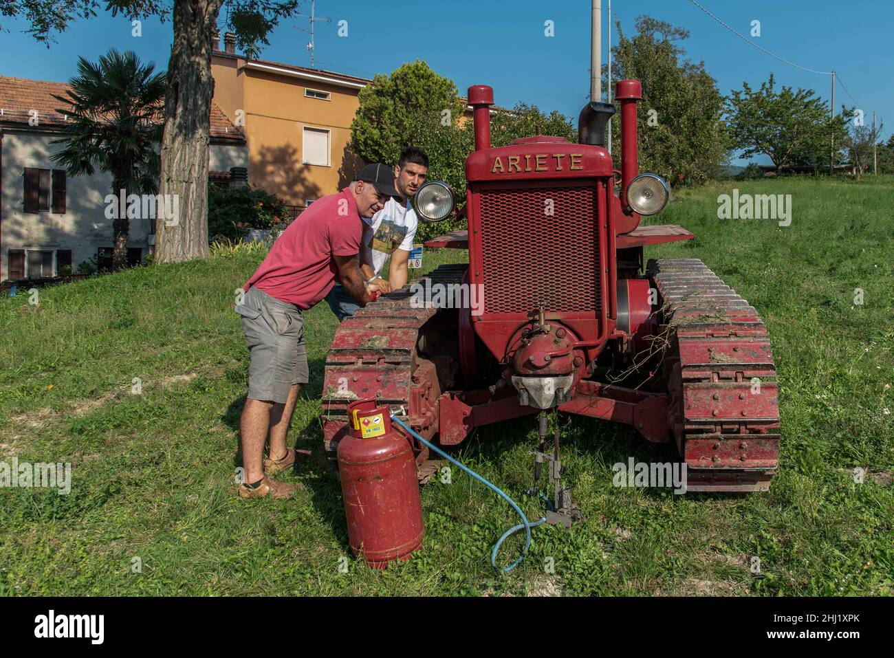 Italian boys start the engine of a Bubba Ariete, hot-headed tractor ...
