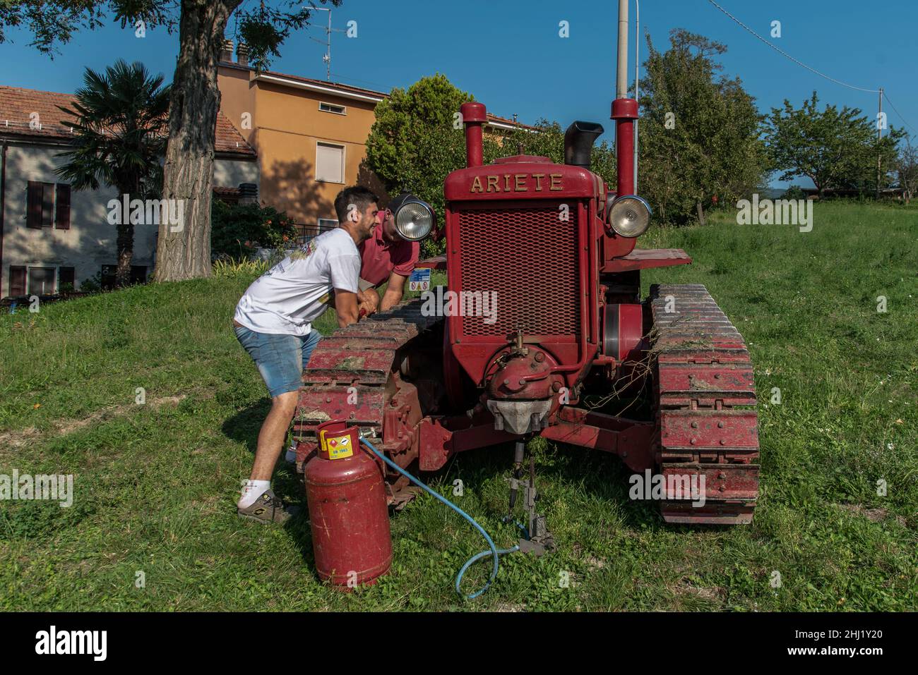 Italian boys start the engine of a Bubba Ariete, hot-headed tractor ...