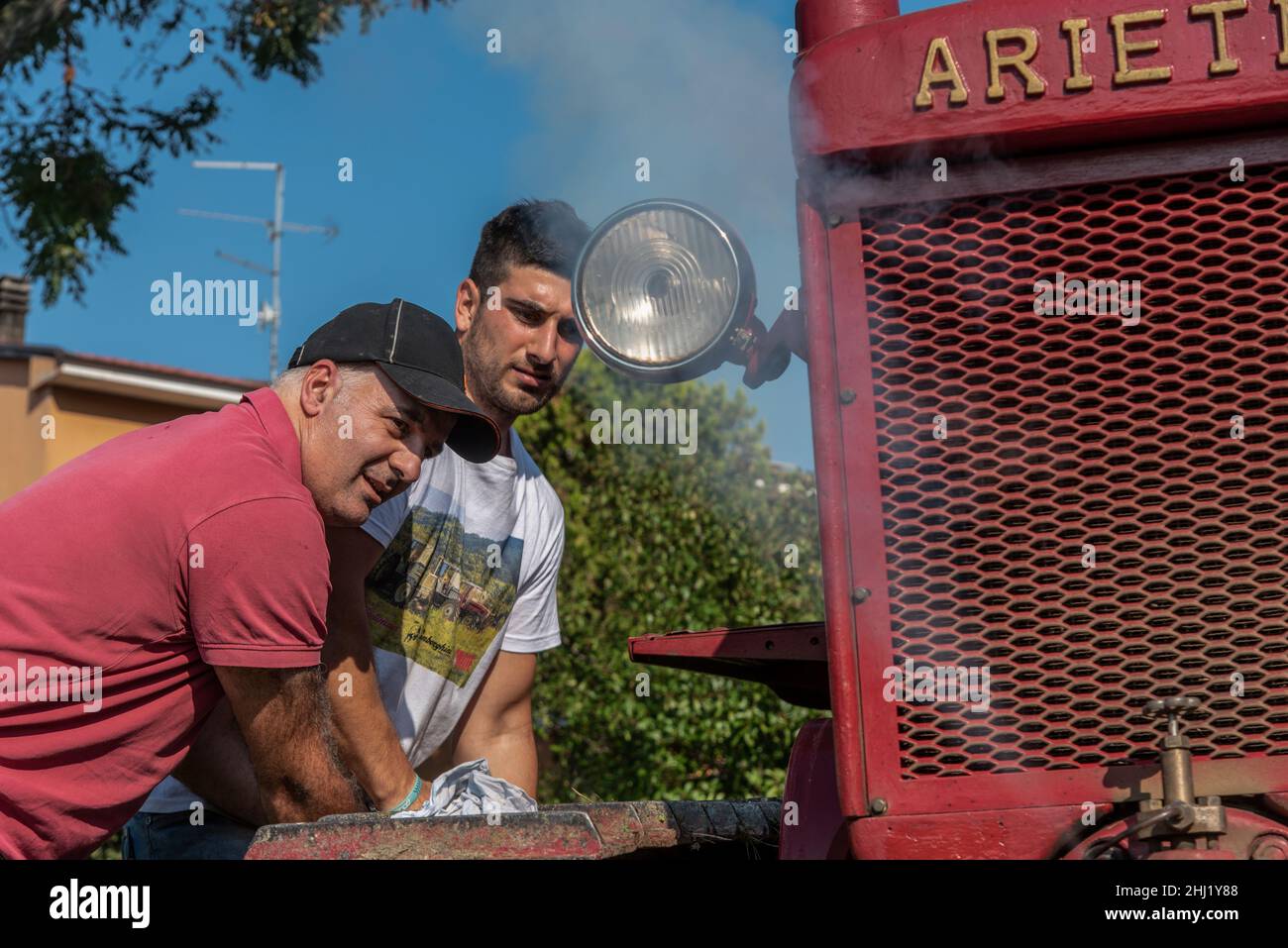 Italian boys start the engine of a Bubba Ariete, hot-headed tractor ...