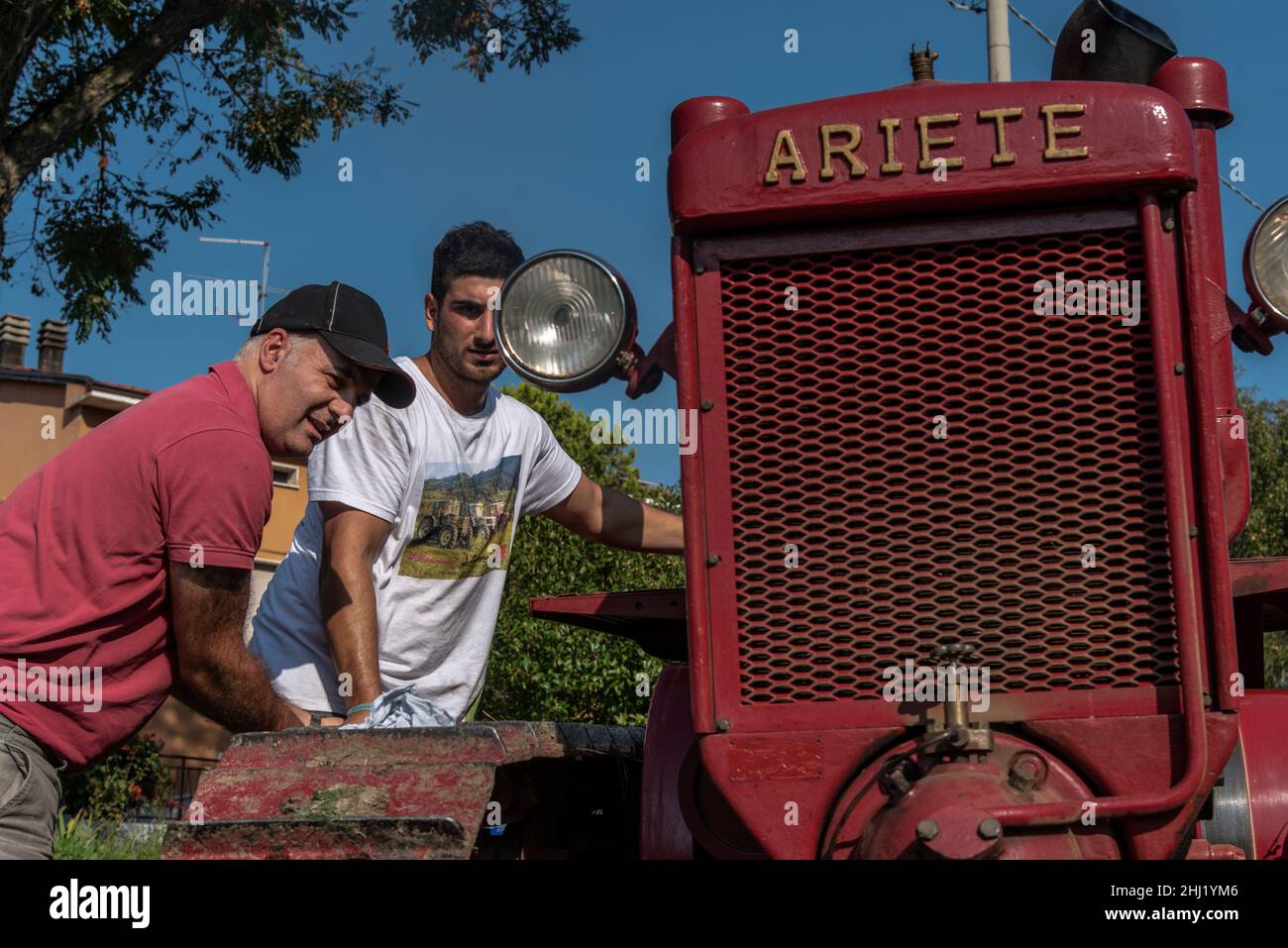 Italian boys start the engine of a Bubba Ariete, hot-headed tractor ...
