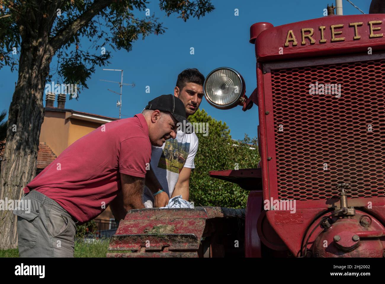 Italian boys start the engine of a Bubba Ariete, hot-headed tractor ...