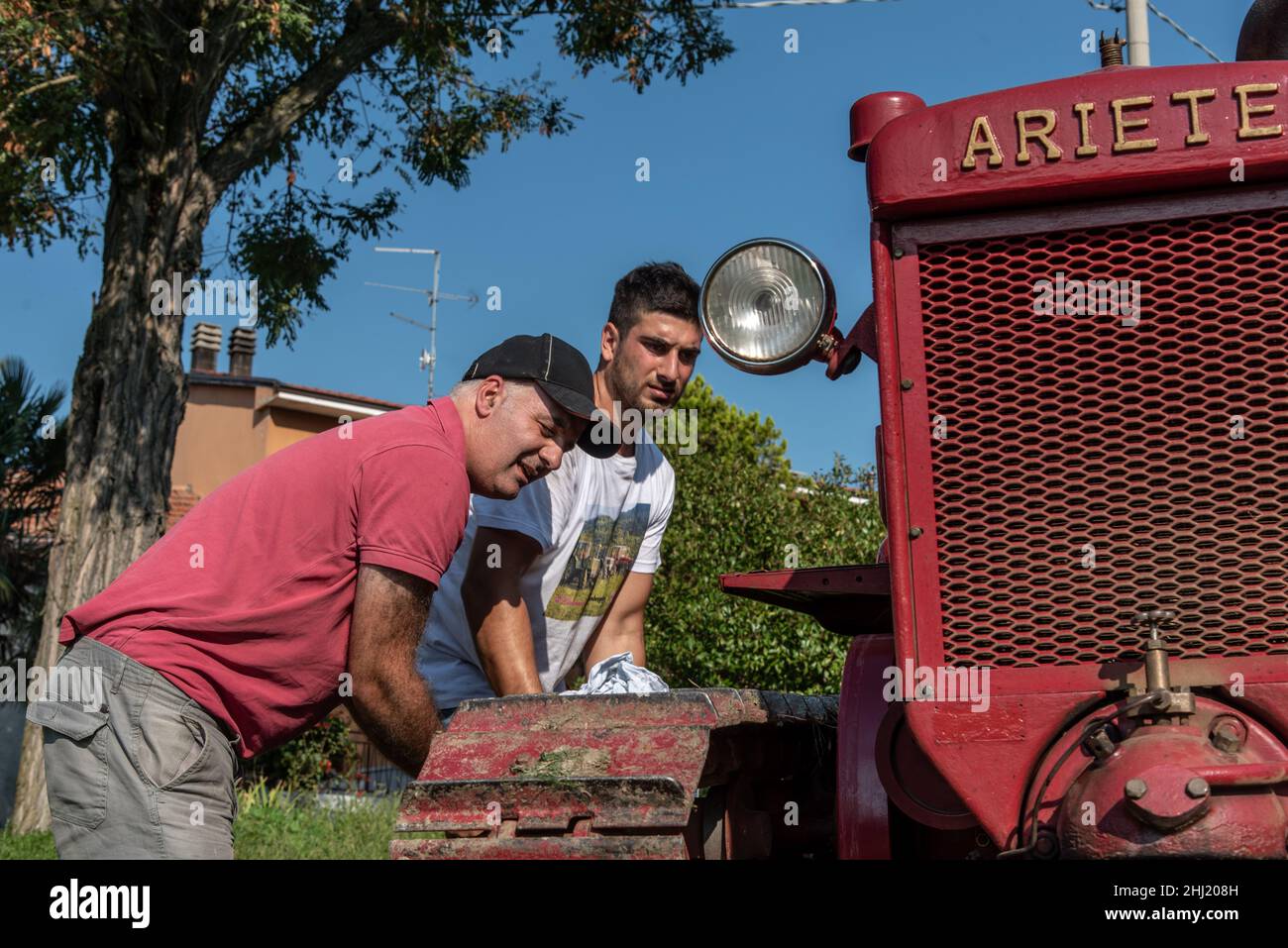 Italian boys start the engine of a Bubba Ariete, hot-headed tractor ...
