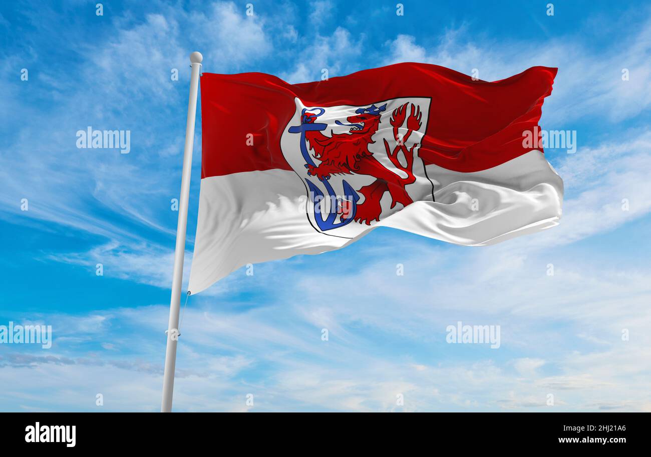 flag of Landeshauptstadt Duesseldorf at cloudy sky background on sunset ...