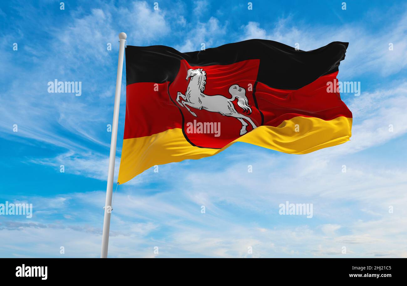 flag of Lower Saxony at cloudy sky background on sunset, panoramic view ...