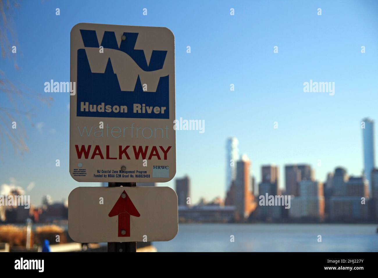 Hudson River Waterfront Walkway sign with red arrow on the river in a ...