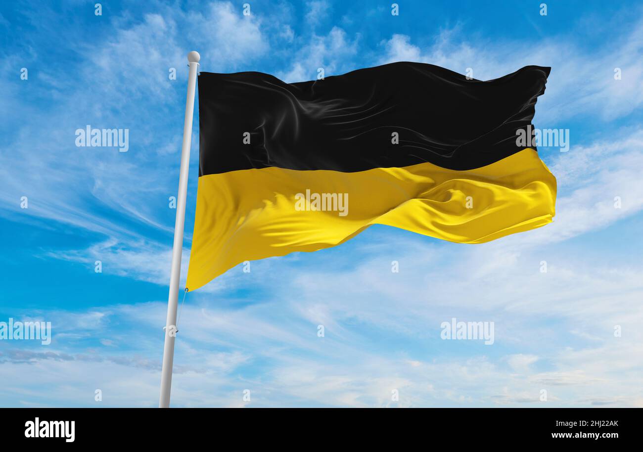 flag of Munster Westfalen at cloudy sky background on sunset, panoramic ...