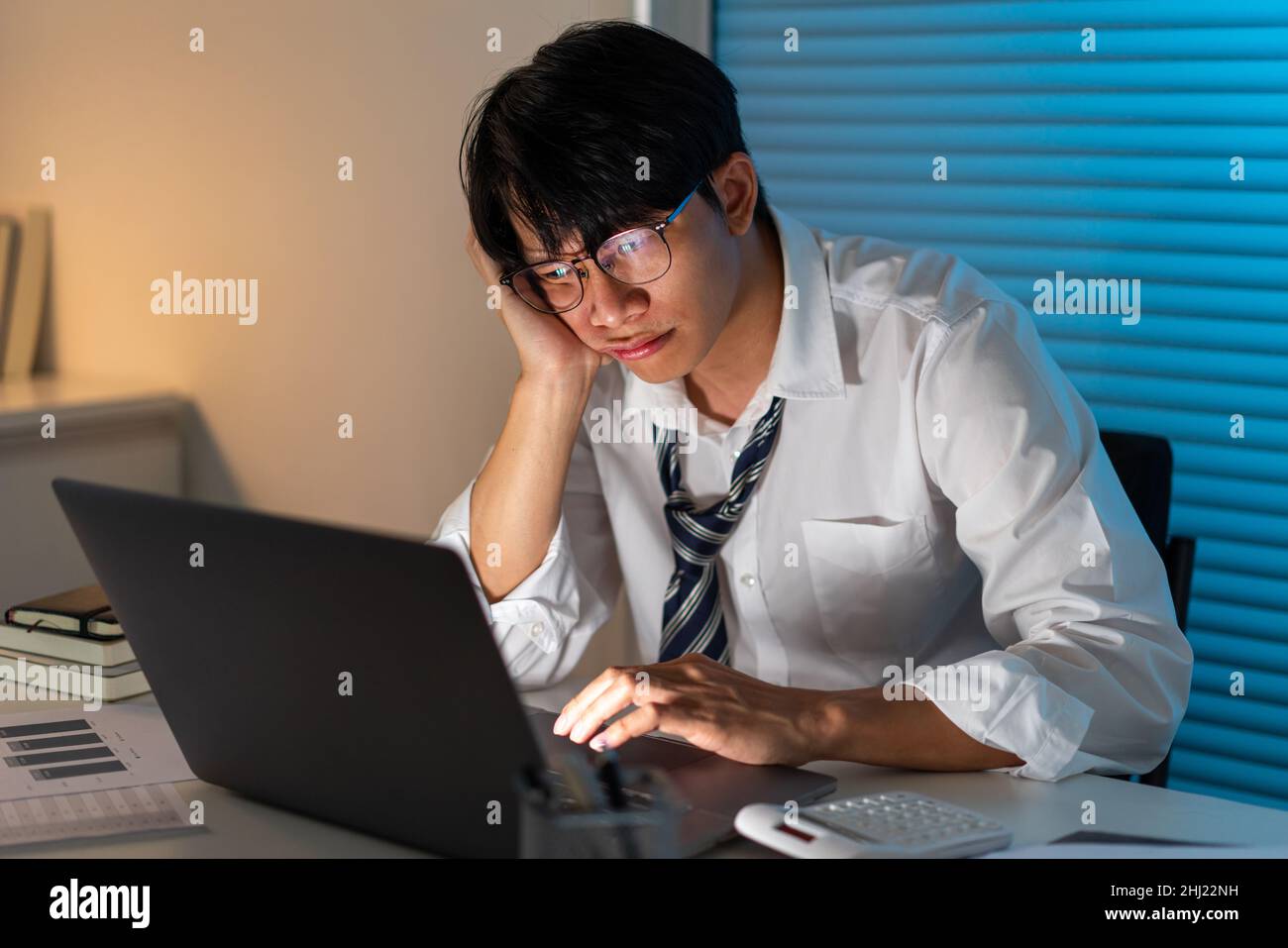 Overwork Concept The male officer resting his face on his right hand ...