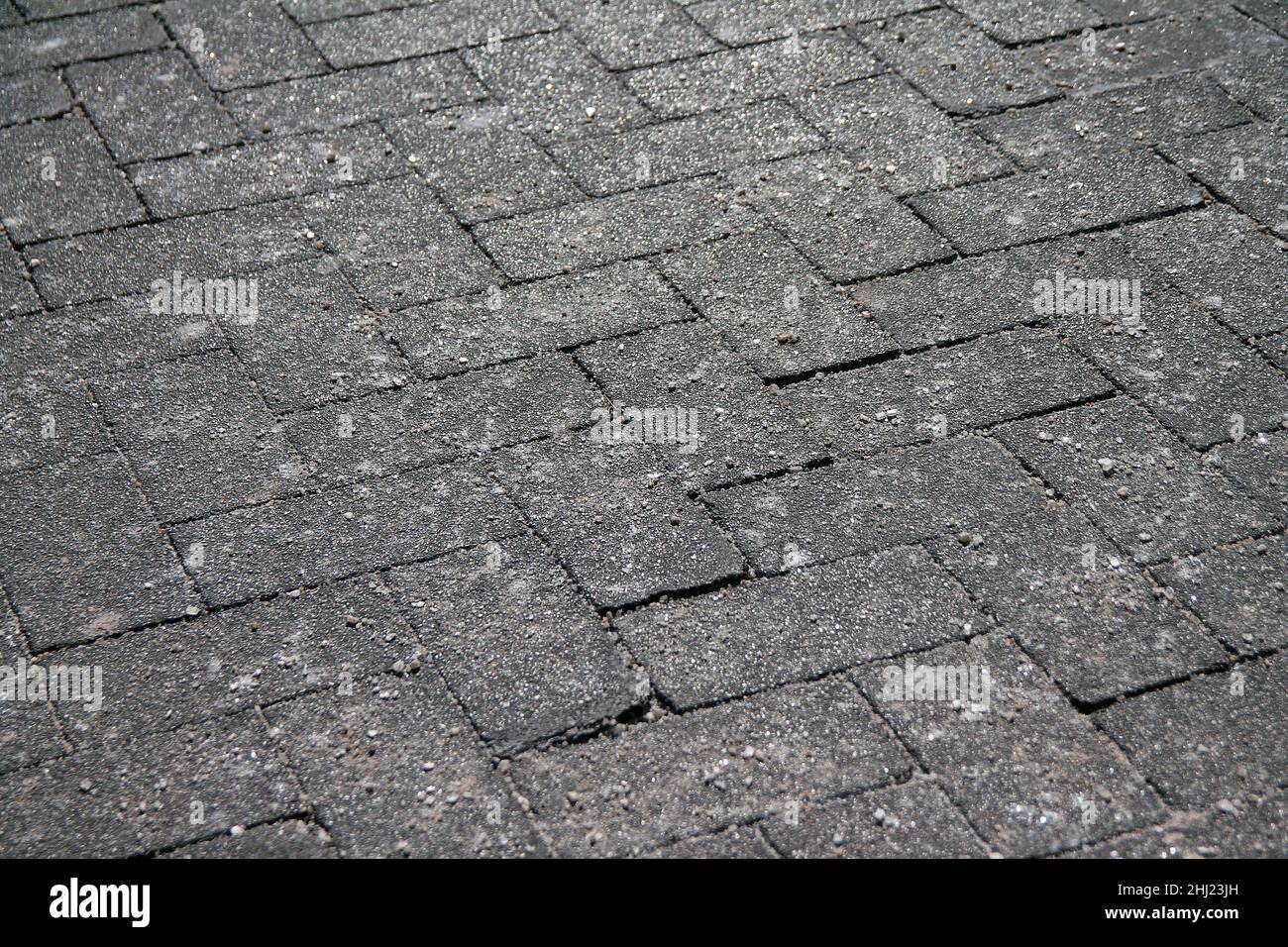 Crystals of salt to prevent the ice on a concrete pavement in a ...