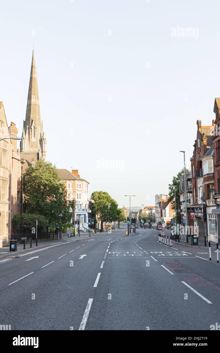 City town street scene, road leads down to the Leicester train station ...