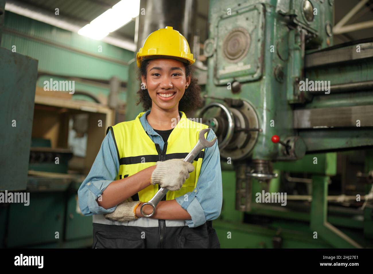Female apprentice in metal working factory, Portrait of working female ...