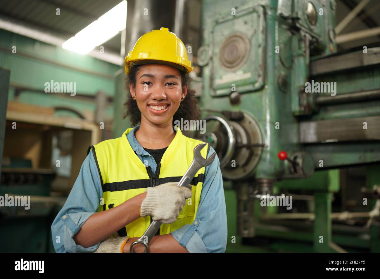 Female apprentice in metal working factory, Portrait of working female ...