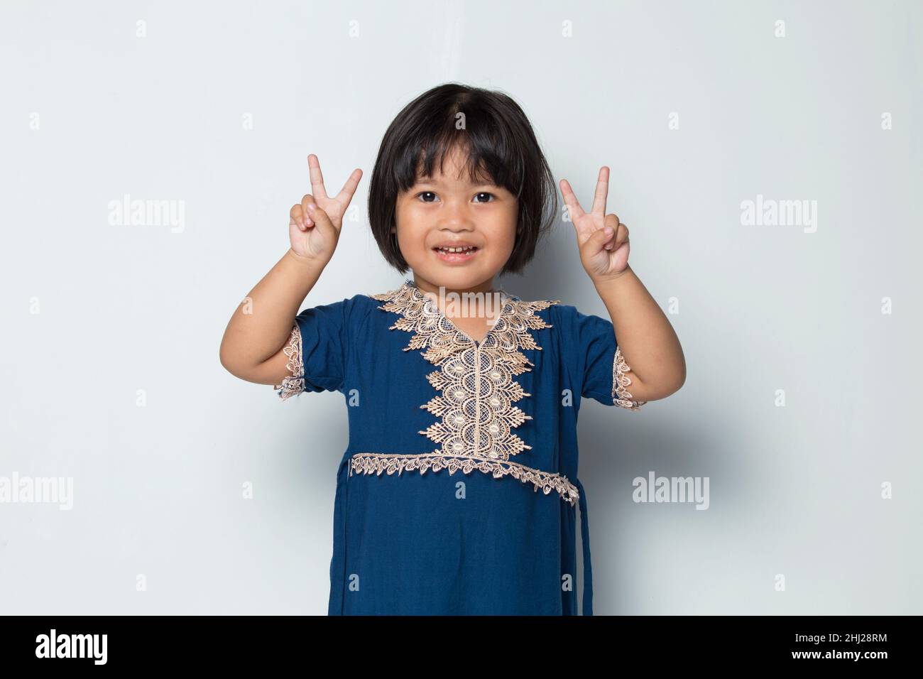 asian little girl showing peace or victory hand gesture isolated on ...