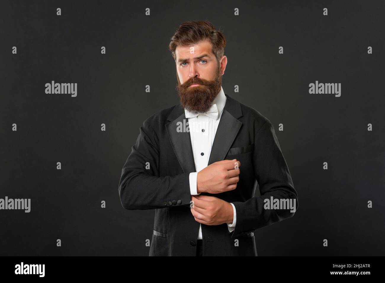 elegant butler in tuxedo on black background, suit Stock Photo - Alamy