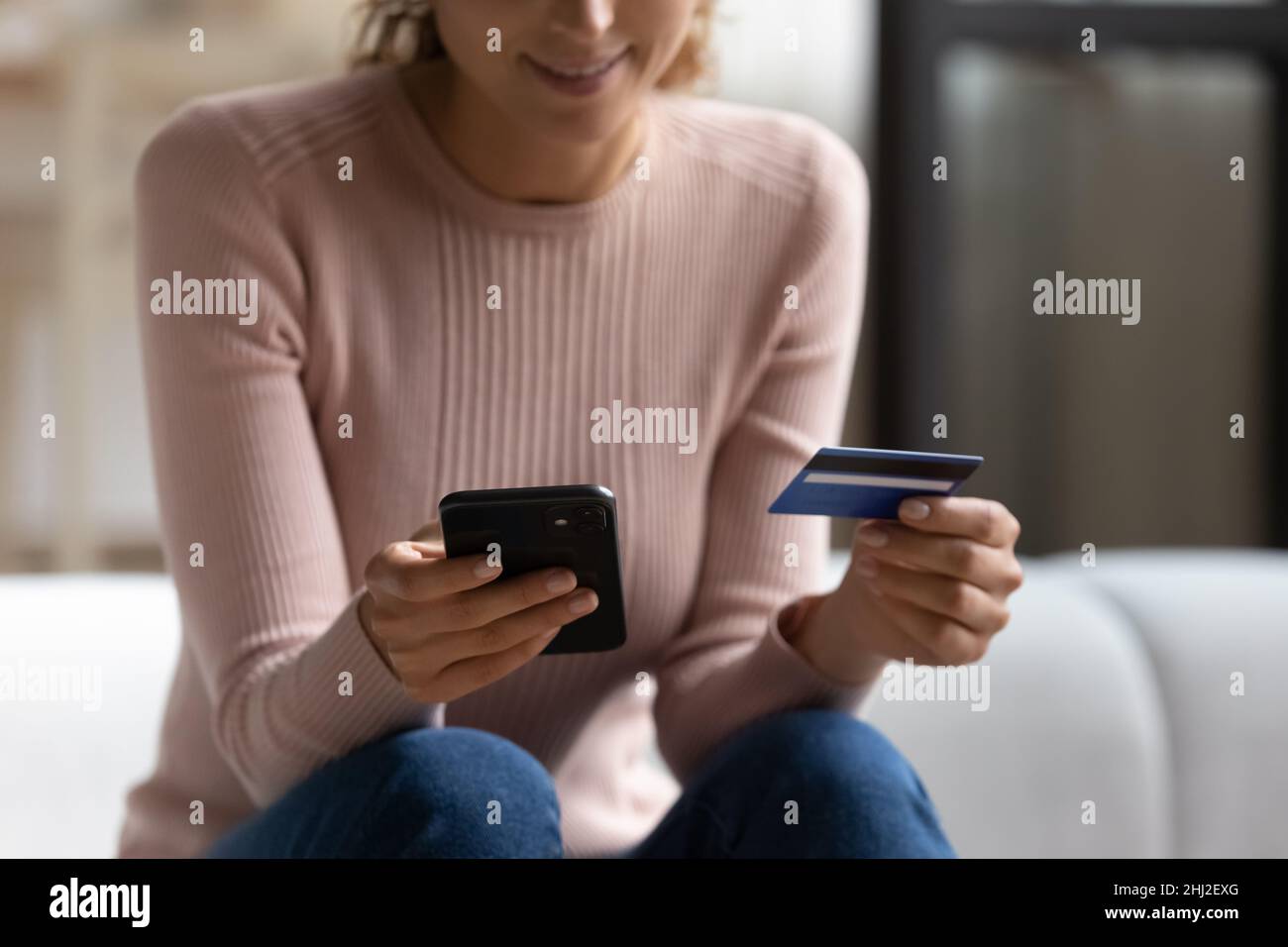 Female makes easy remote e-payment using smartphone and credit card ...