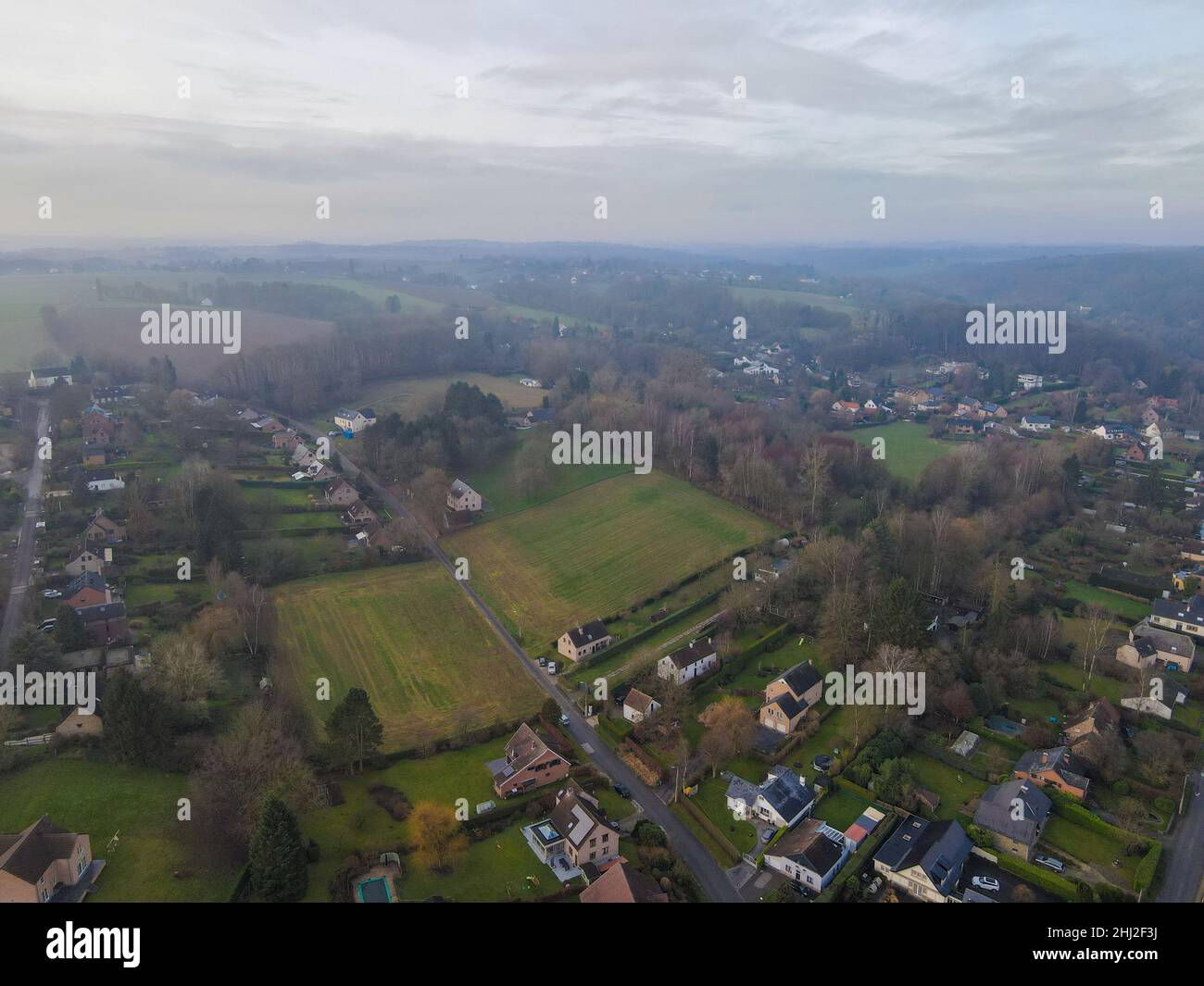 Aerial view of houses surrounded by forest in the country side area of ...