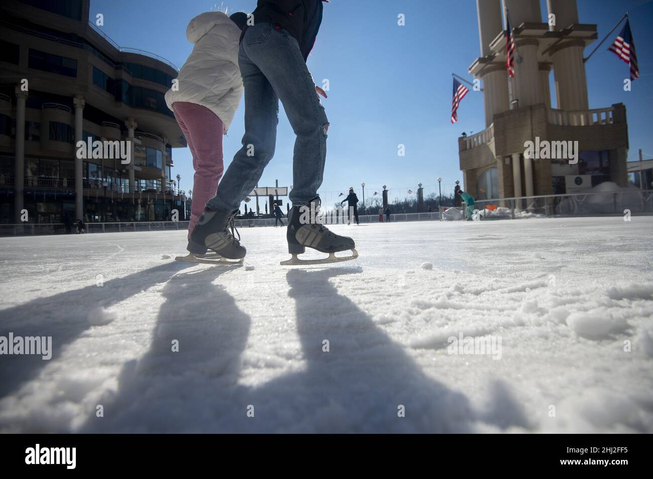 Washington, United States. 26th Jan, 2022. Two friends hold hands while ...