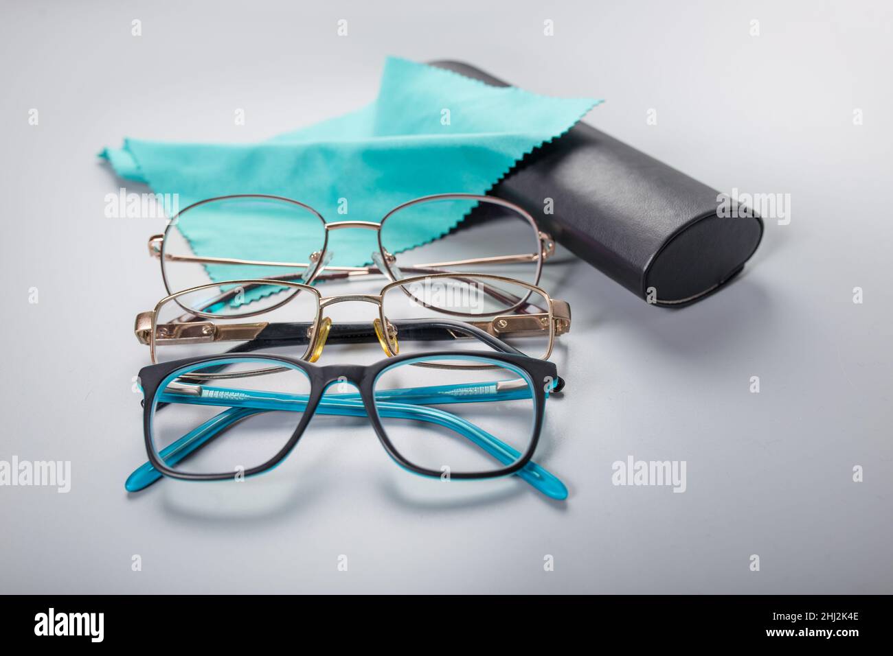 Different frames for eye glasses close up with napkin and case, on grey ...
