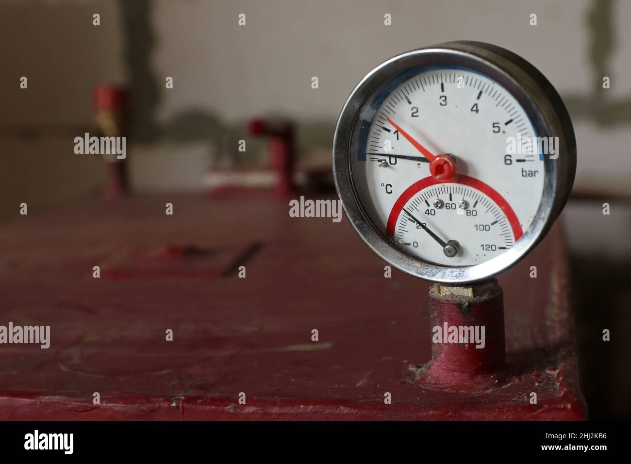 Thermometer on wood central heating system's top. Modern boiler for ...