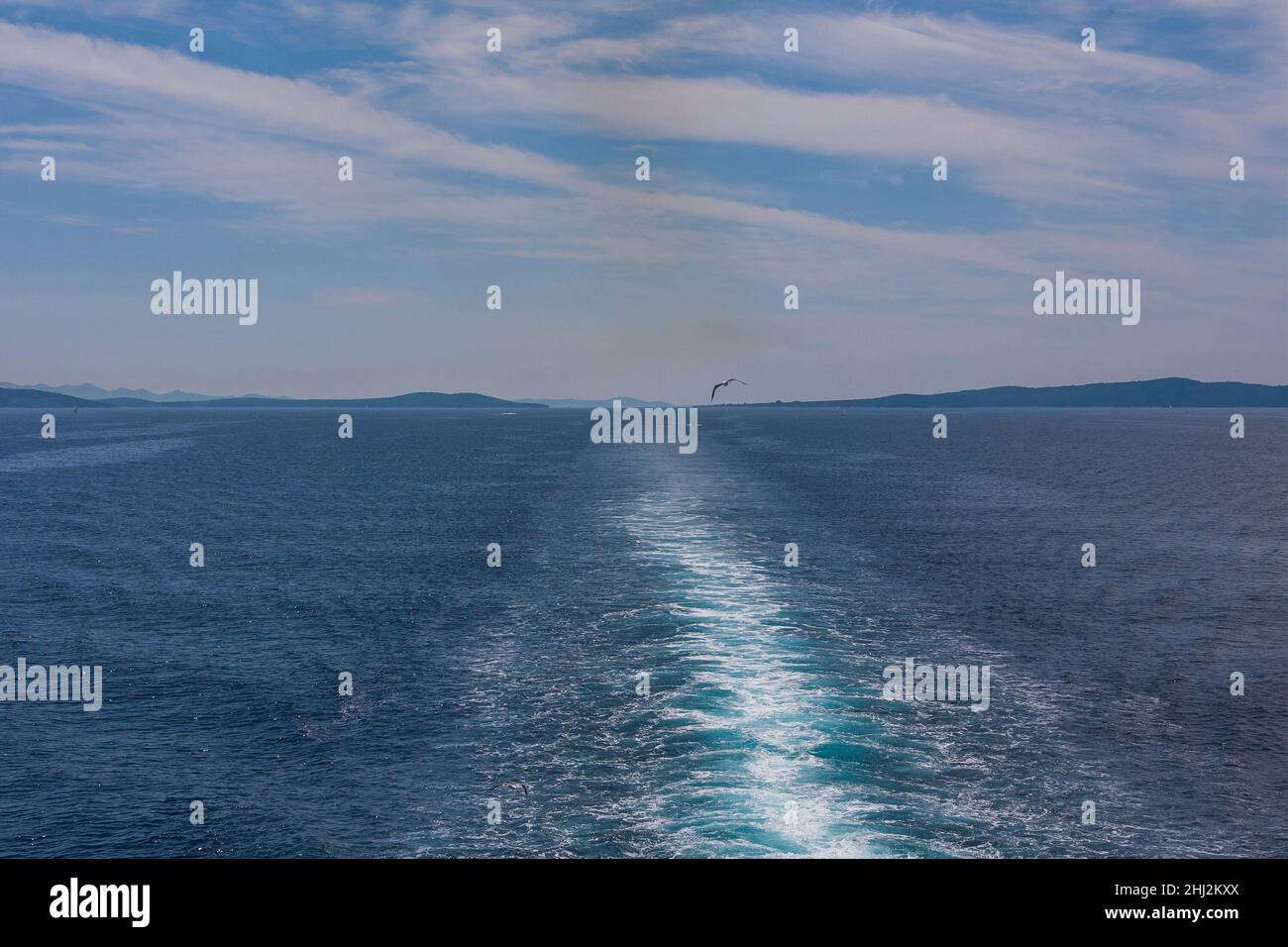 View of the sea behind sailing ships at sea. Blue sky Stock Photo - Alamy