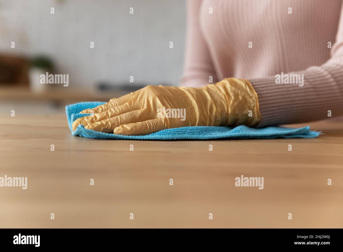 Closeup female hand in glove cleaning wooden countertop with rag Stock ...