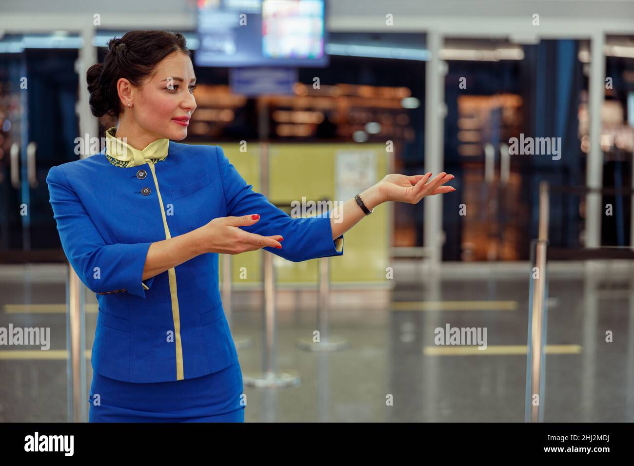 Female flight attendant welcoming to flight at airport Stock Photo - Alamy