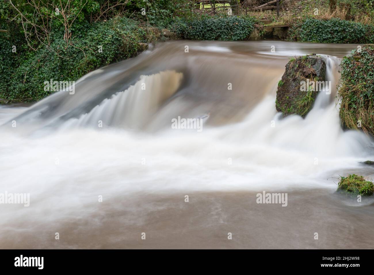 Long exposure of a waterfall on the river Avill in Dunster in Somerset ...