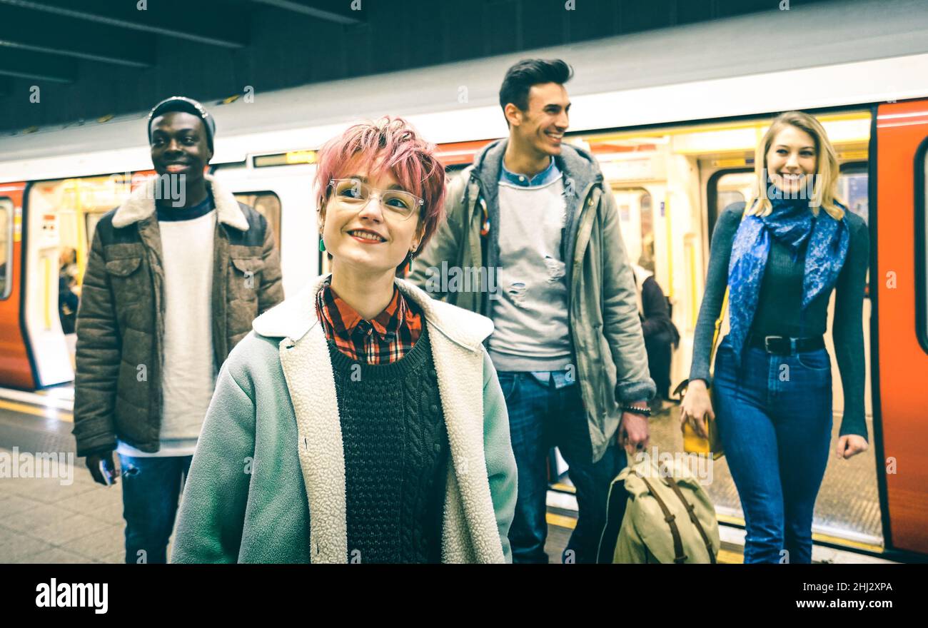 Multiracial hipster friends group walking at tube subway station ...