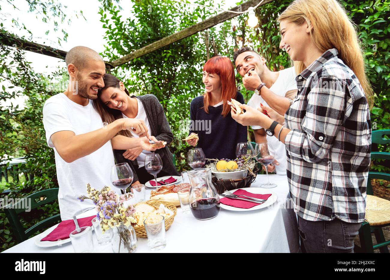 Happy people having fun eating food at restaurant garden fest ...