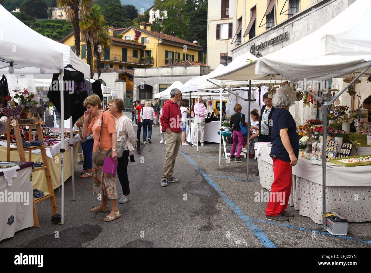 Menaggio, Lake Como, Italy - June 2019: People looking at goods on ...