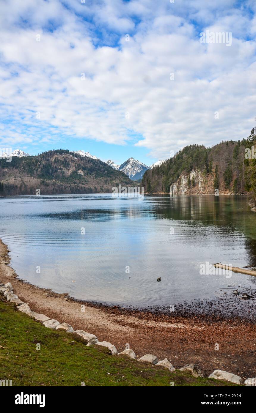Vertical shot of the natural scenery of a lake and hills at the foot of ...