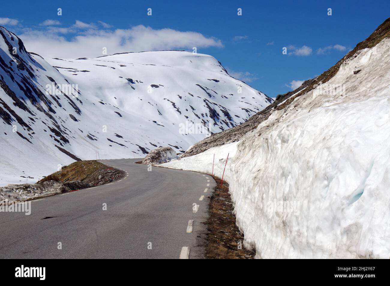 Road leads up along high snow walls and snowy mountains, Langvatn ...