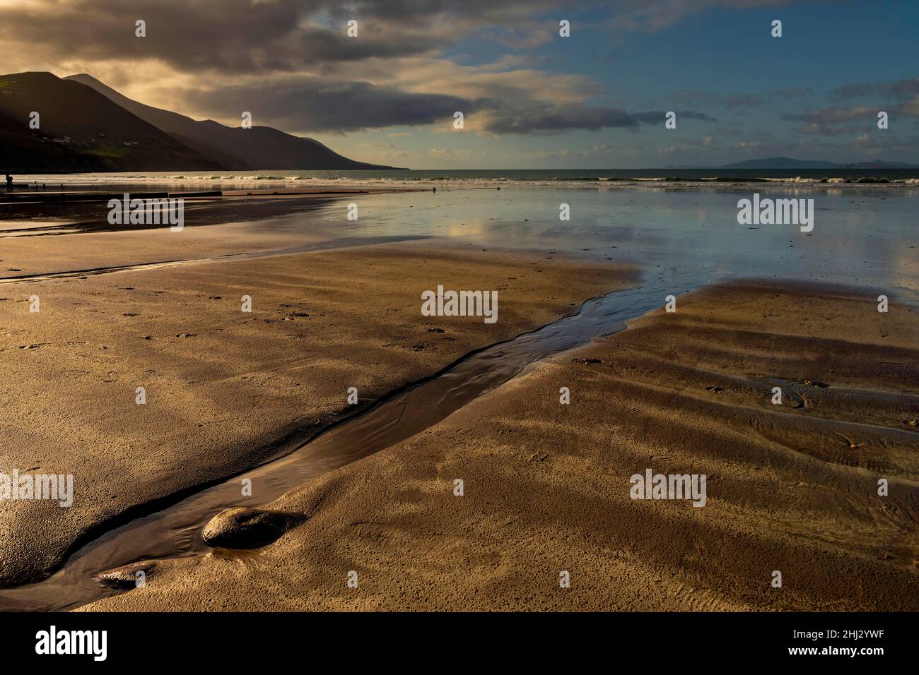 Sandy beach beach and mountains and cloudy sky in the background ...