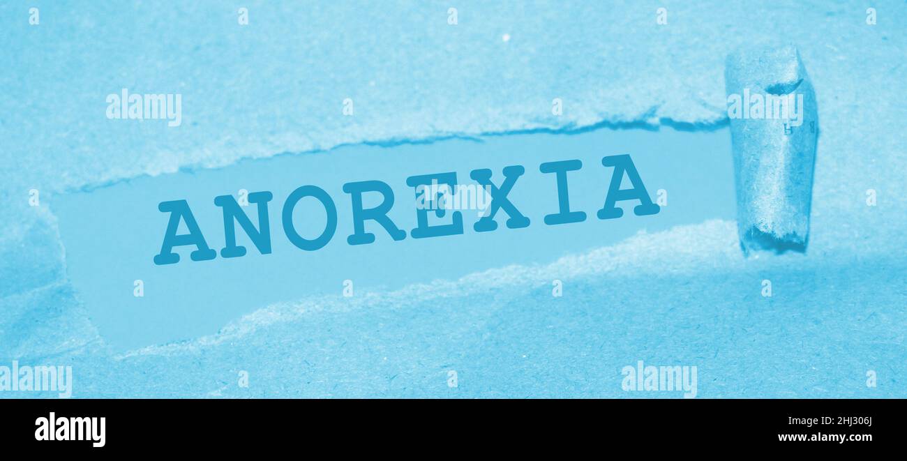Anorexia word appearing behind brown torn paper. Eating disorders women ...