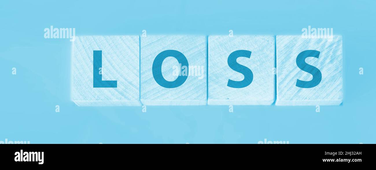 Wooden cubes with LOSS word on sky blue background. Financial loss ...