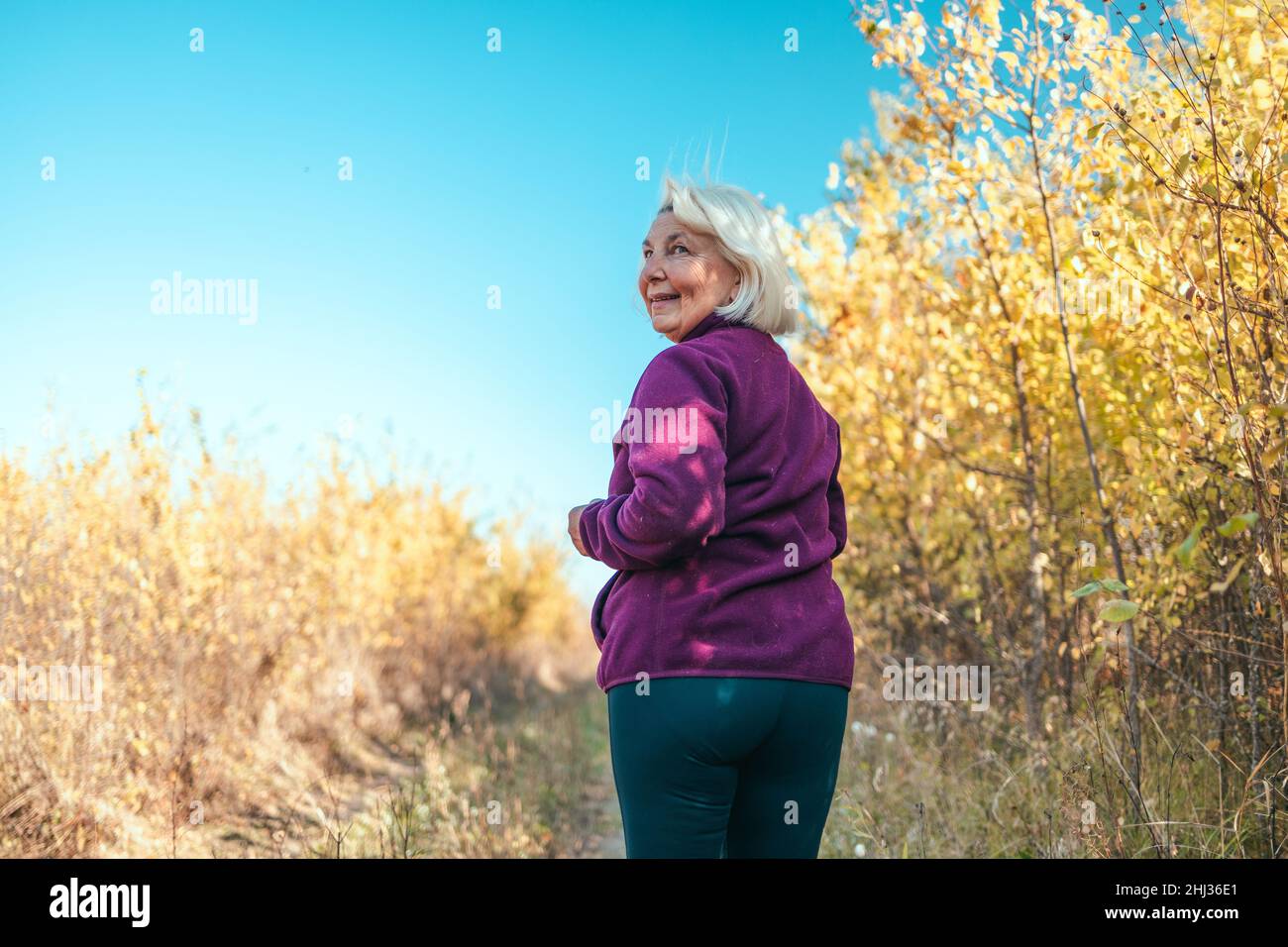 Beautiful sporty mature female staying fit with sport in nature. Active ...