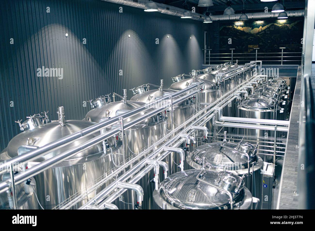 Private microbrewery. Modern beer plant with brewering kettles, tubes ...