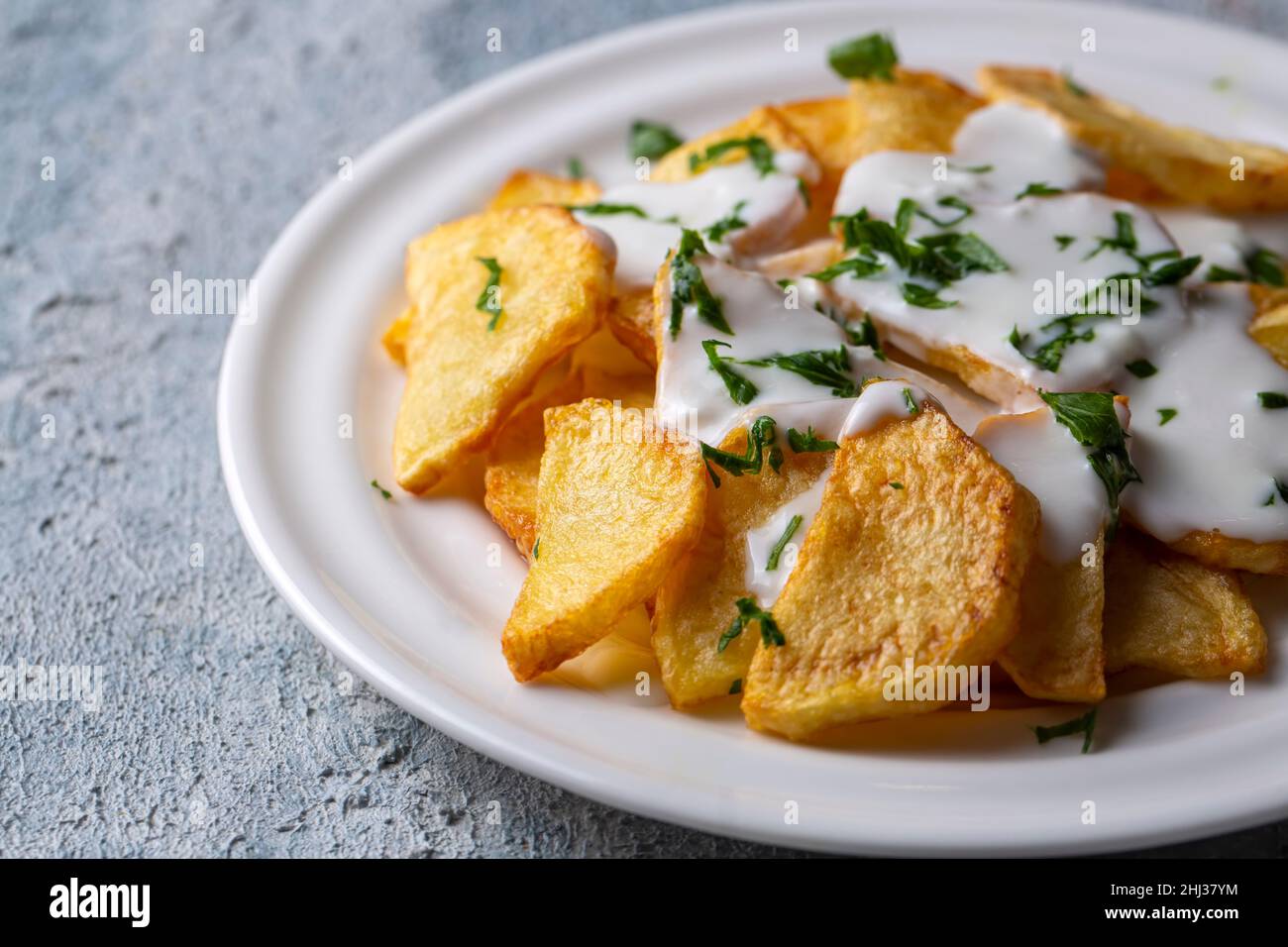 Traditional delicious Turkish foods, fried potatoes with yoghurt ...
