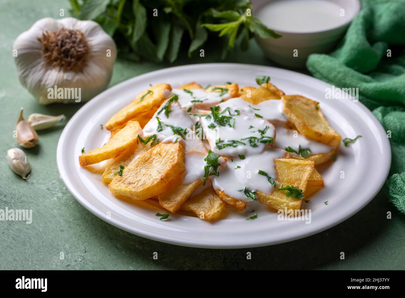 Traditional delicious Turkish foods, fried potatoes with yoghurt ...