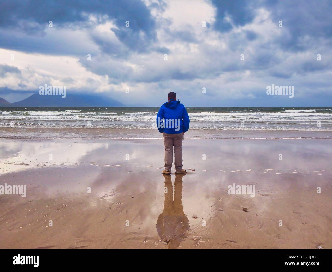 Man alone on the beach view of the sea, Ireland Stock Photo - Alamy