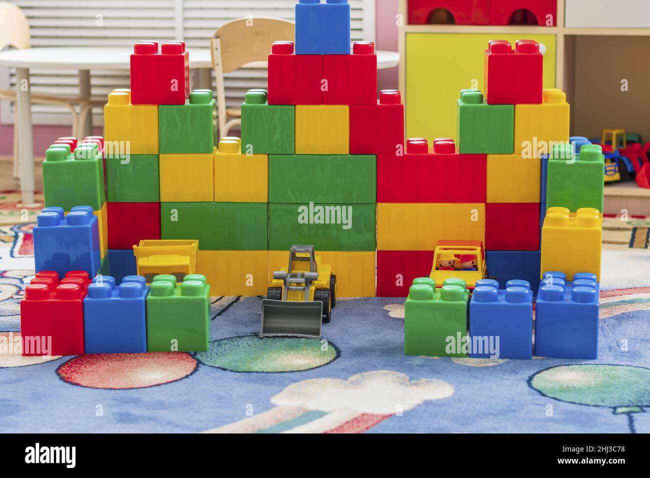 Children's playground - wall made of colored plastic blocks and several ...