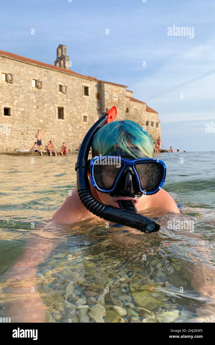 Teenage boy diving in the sea using underwater dive mask Stock Photo ...