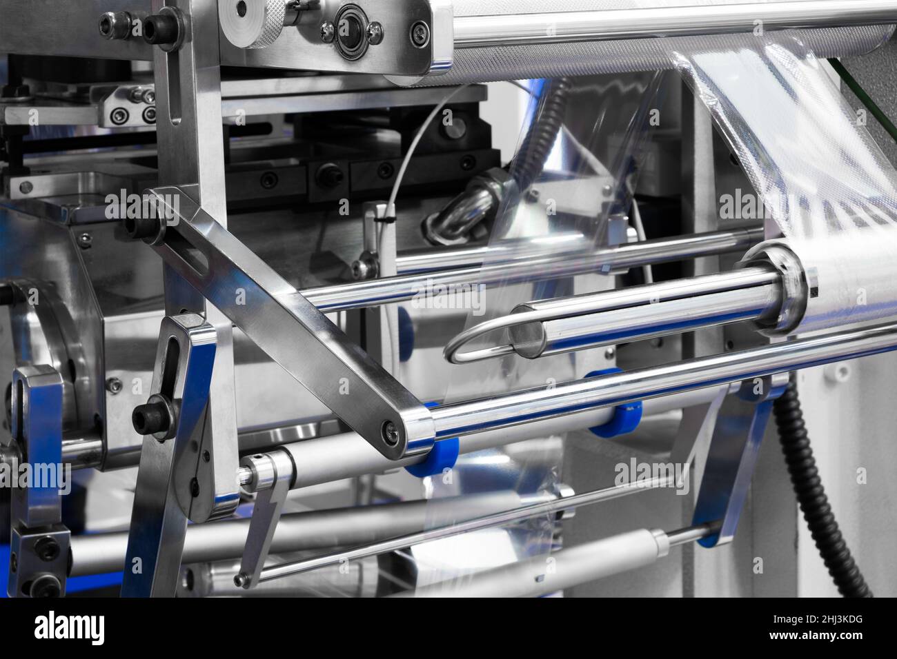 The operation of automatic plastic bag production machine. Close-up of ...