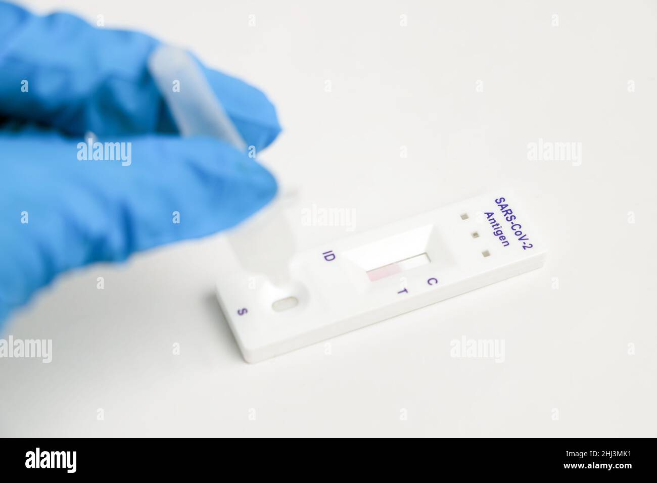 Man makes a covid-19 antigen pcr test macro. The test showed a positive ...