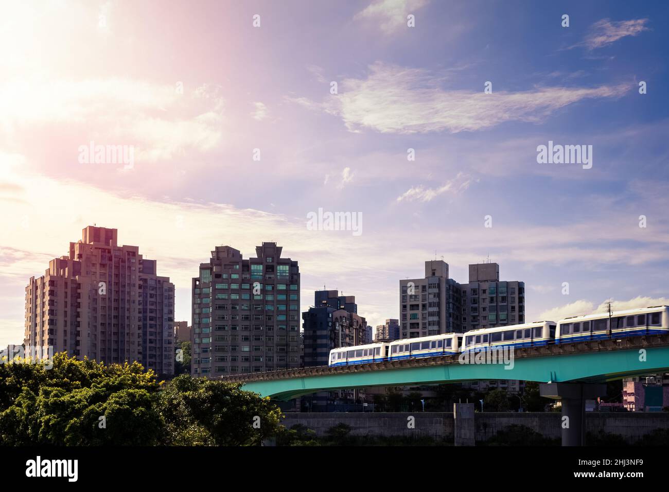 Elevated train passing over bridge. Awesome cityscape with modern metro ...