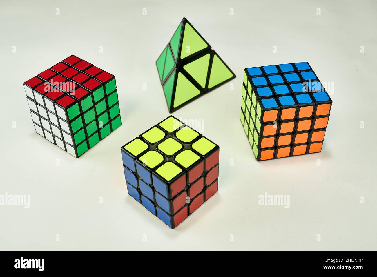 several solved rubik's cubes on white background Stock Photo - Alamy