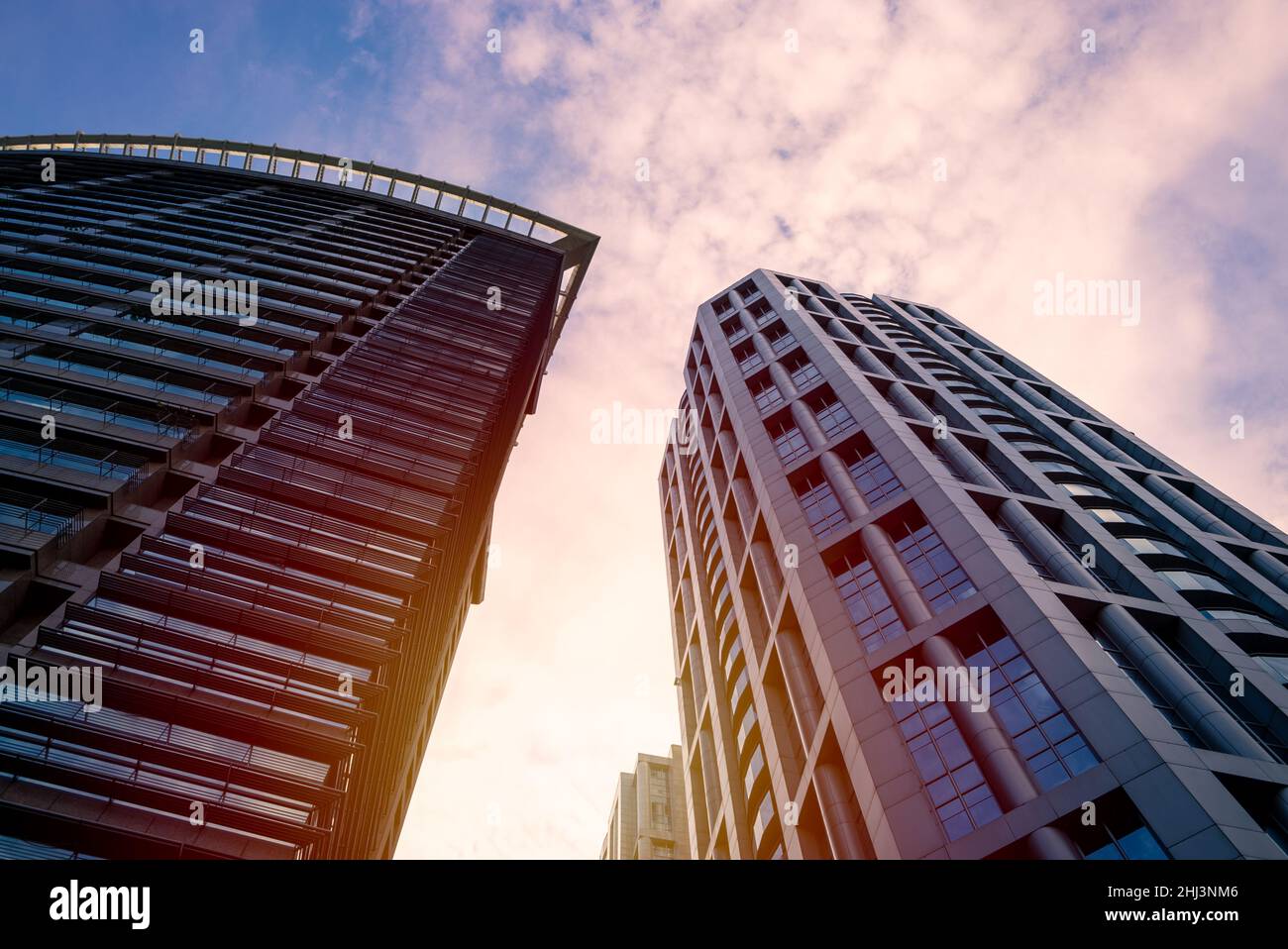 Beautiful and modern tall tower with clouds in the financial district ...