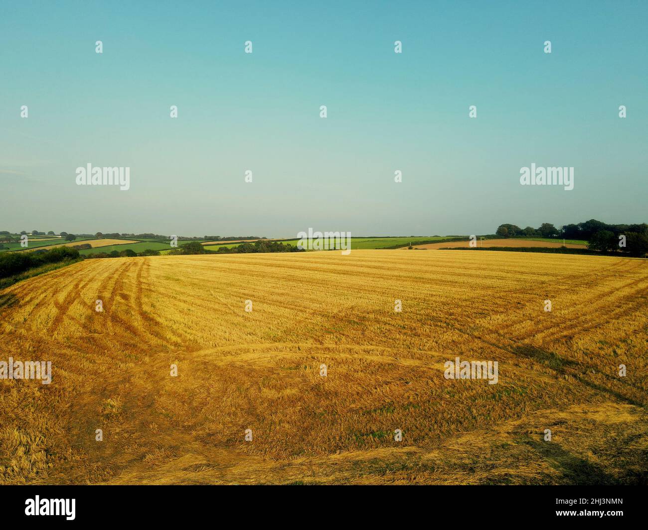 Lovely vibrant image taken of a crop field leading into some hills and ...